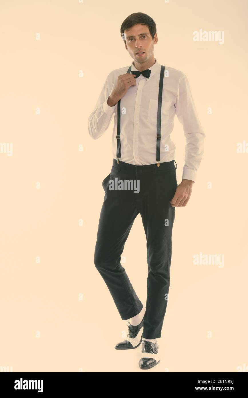 Full body shot of young handsome man posing while wearing suspenders ...