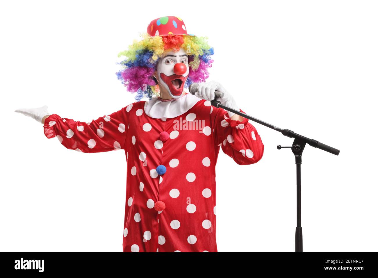 Full length portrait of a funny clown with a microphone isolated on ...