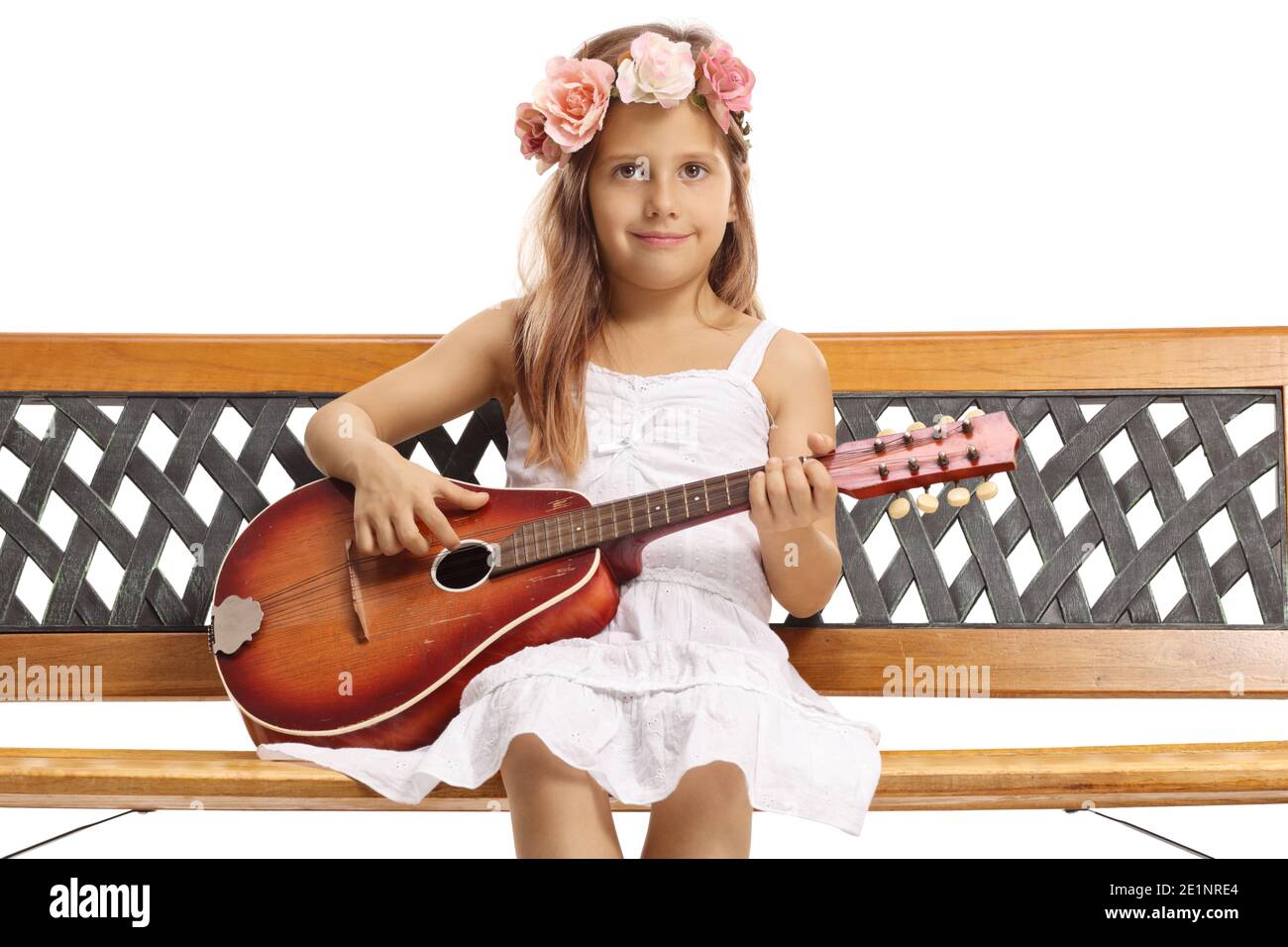 Little girl sitting on a bench and playing a mandolin isolated on white ...