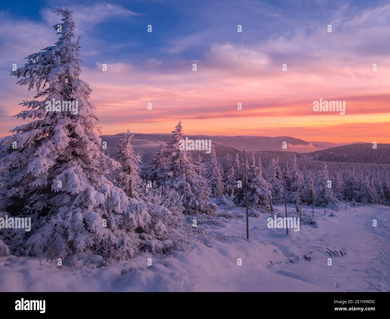 Scenic snowy landscape with a view from a mounatin range to the valley ...
