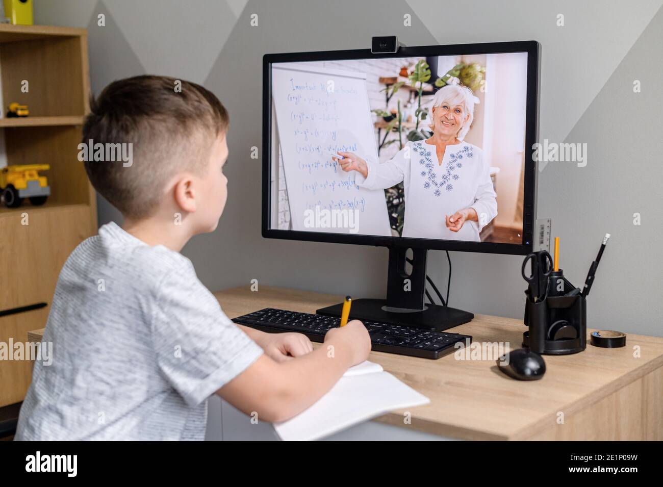 Schoolkid watching online video classes on the PC Stock Photo - Alamy