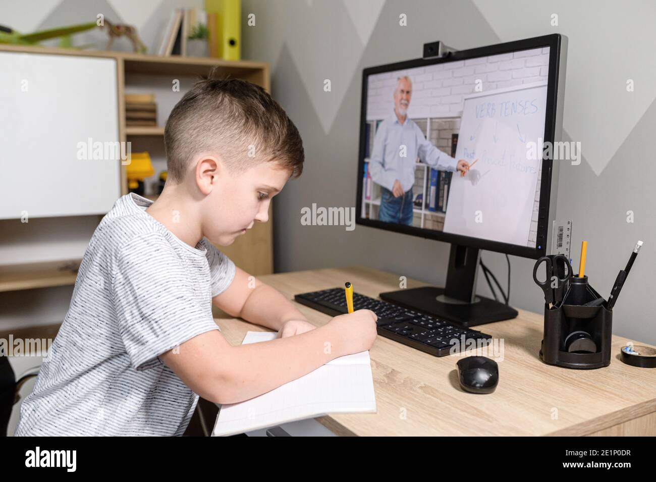 Schoolkid watching online video classes on the PC Stock Photo - Alamy