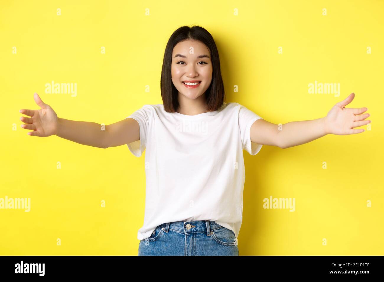 Beauty and fashion concept. Friendly asian woman spread out hands and ...