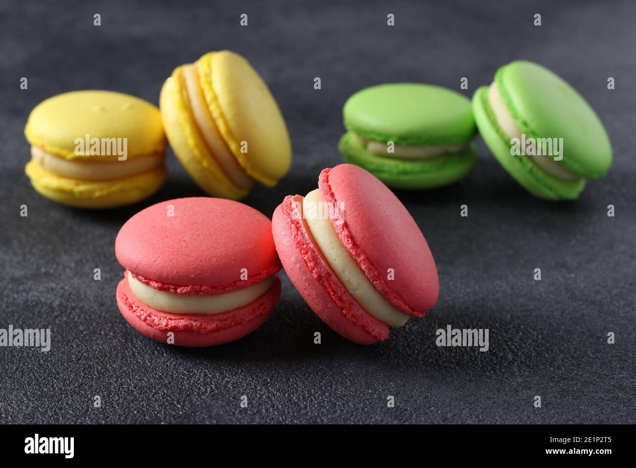 Colorful french macaroons on dark grey background. Close-up. Horizontal ...