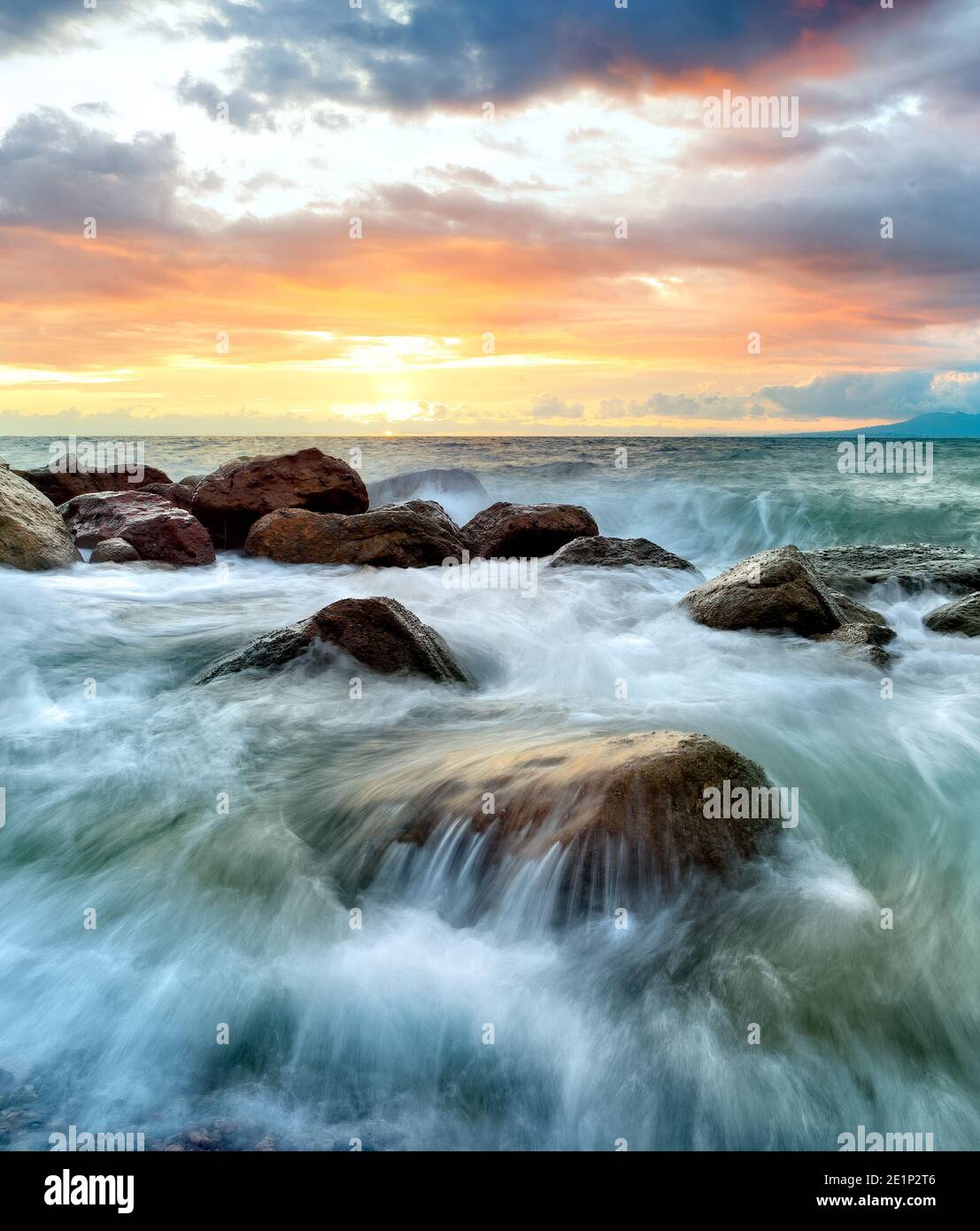 A Colorful Ocean Sunset Sky as a Gentle Wave Rolls to Shore in a ...