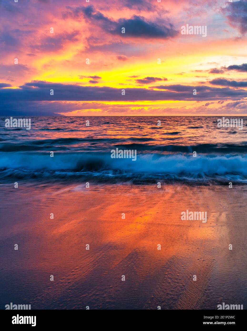 A Colorful Ocean Sunset Sky as a Gentle Wave Rolls to Shore Stock Photo ...