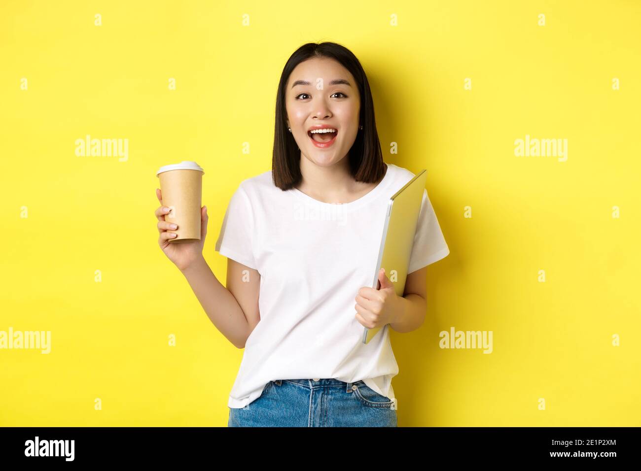Happy asian woman drinking coffee and holding laptop, saying hi to you ...