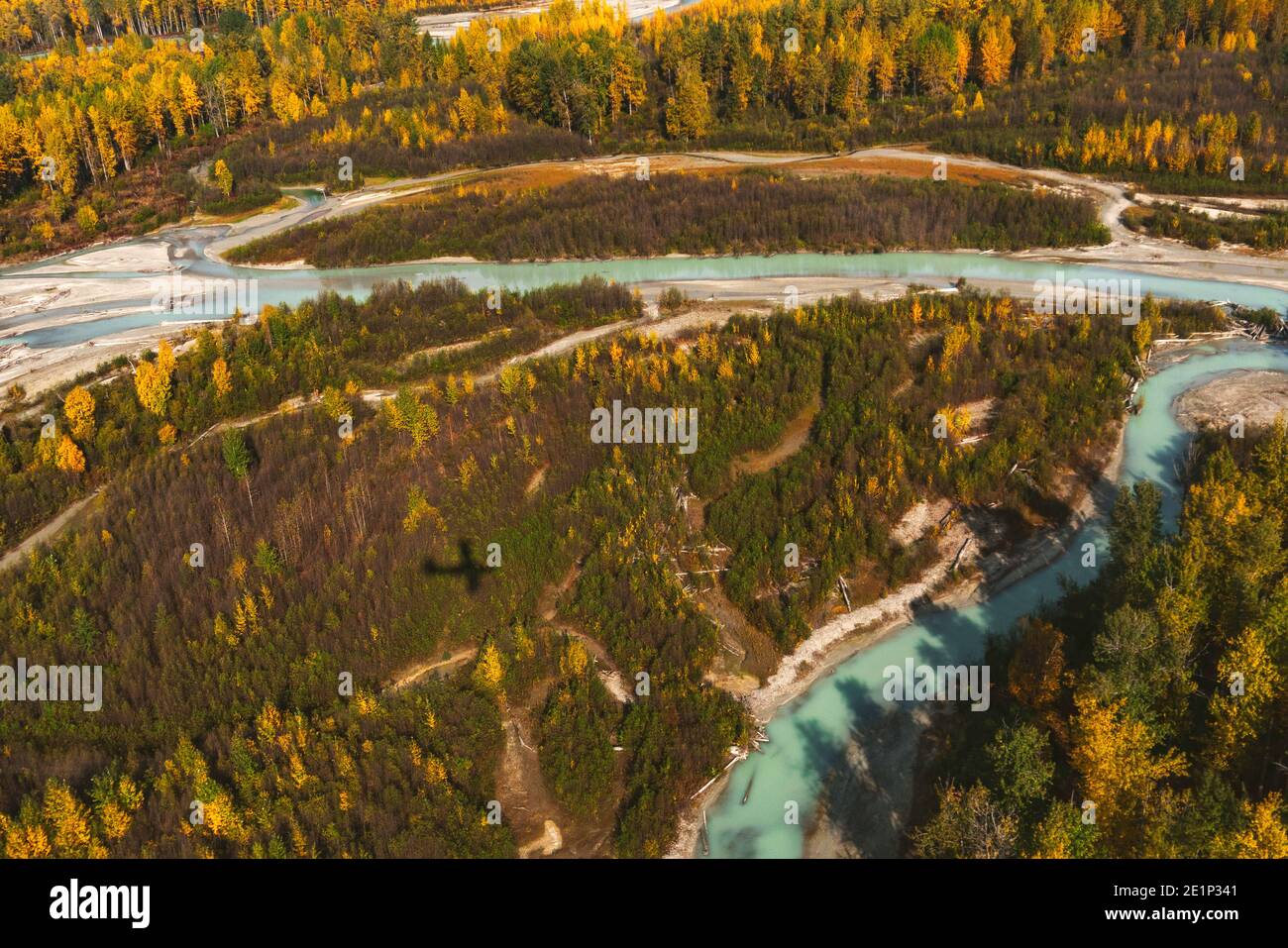 Shadow of an airplane with rivers and fall colors in Alaska Stock Photo ...