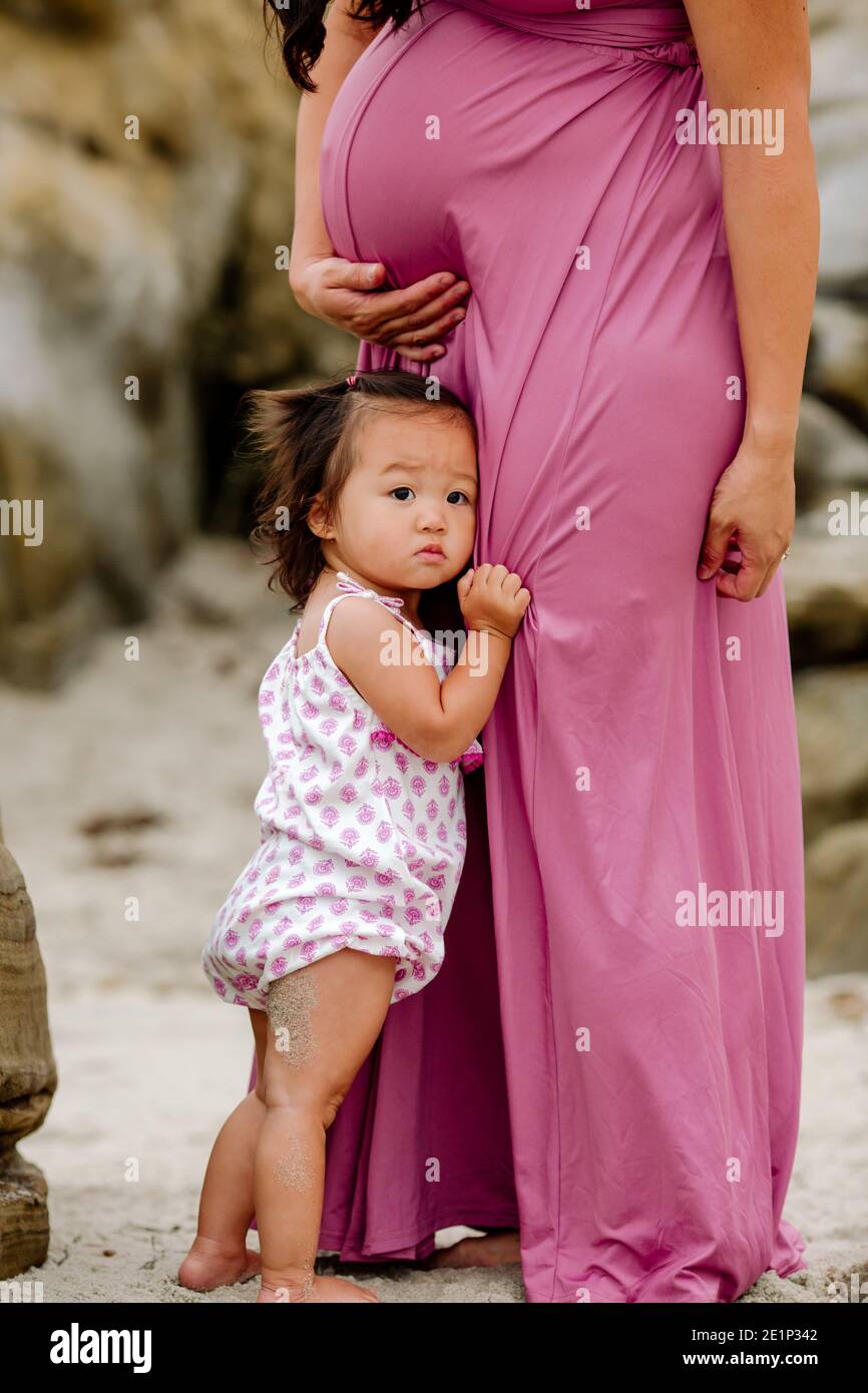Child clings to mother hi-res stock photography and images - Alamy