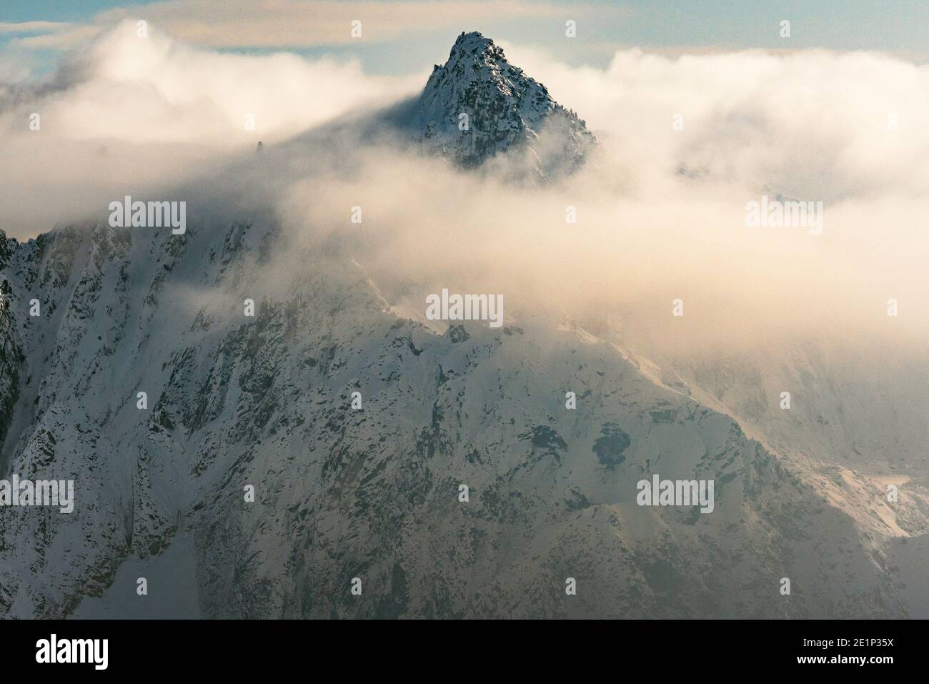 Aerial view of Avalanche Spire hiding in the clouds at sunset Stock ...