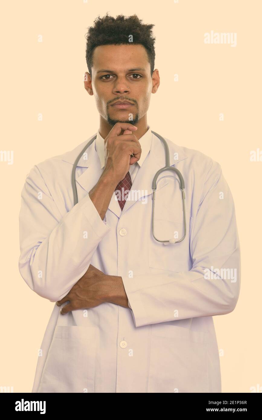 Studio shot of young African man doctor thinking Stock Photo - Alamy