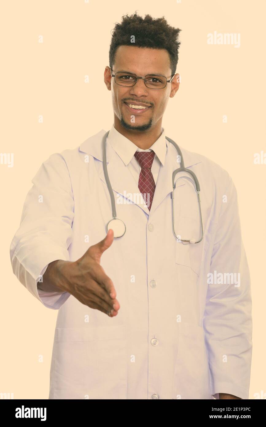 Young happy African man doctor smiling and giving handshake Stock Photo ...