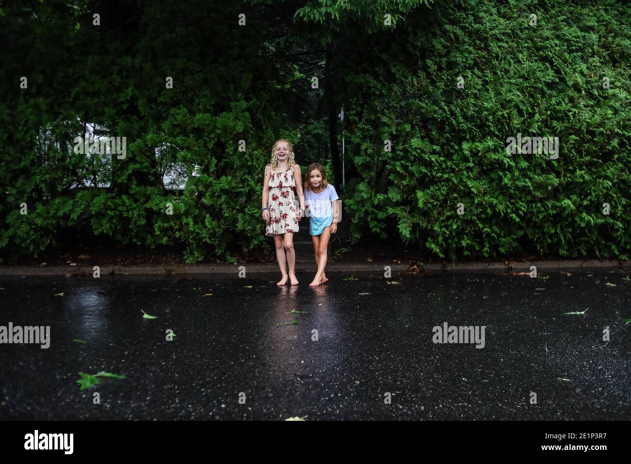 portrait of two girls standing in the rain Stock Photo - Alamy