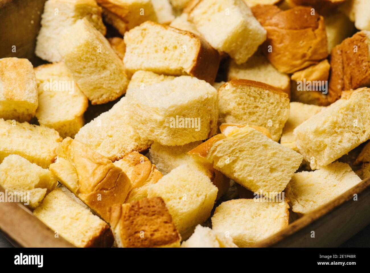 Cubed pieces of brioche bread in a pan for a recipe Stock Photo - Alamy