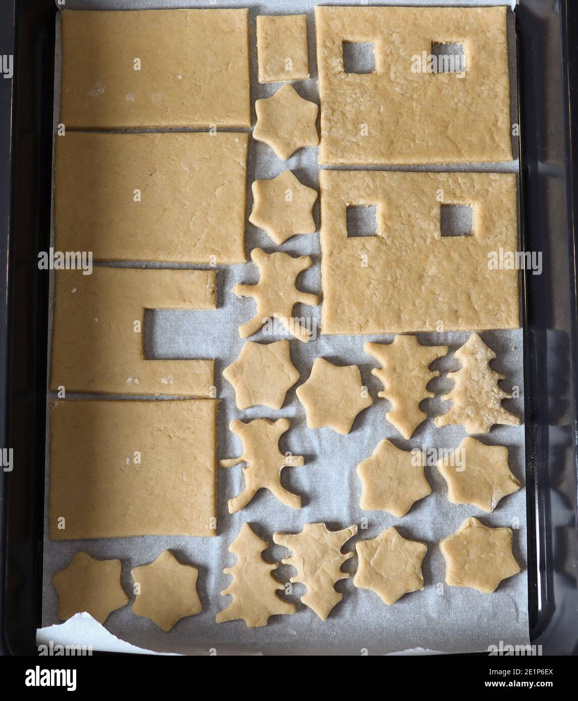 Pieces of biscuit cake ready to bake in a pan. Christmas and home made ...