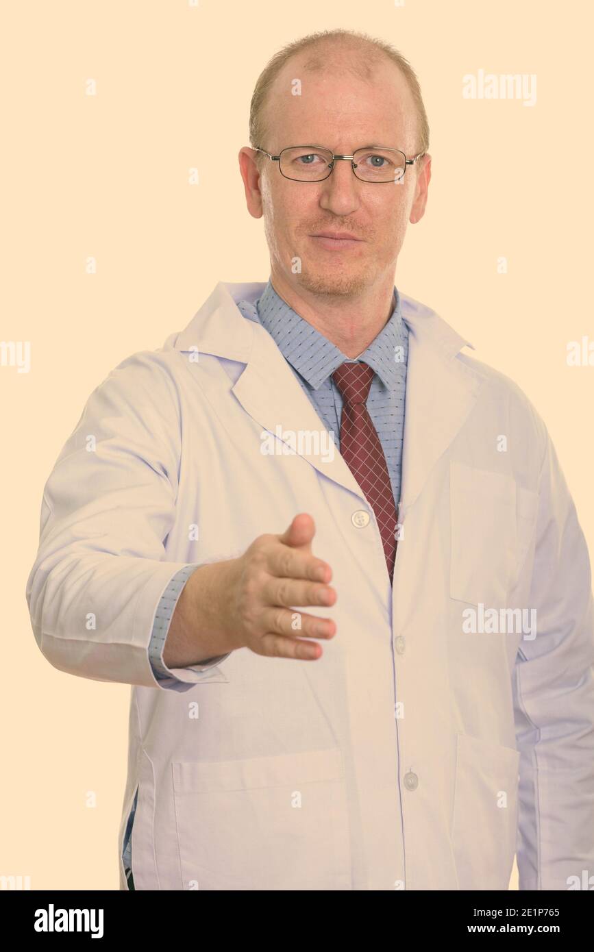 Studio shot of man doctor giving handshake Stock Photo - Alamy