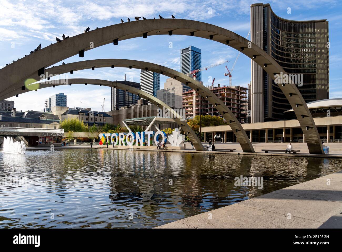 Arches and new Toronto sign on Nathan Phillips Square with city skyline ...