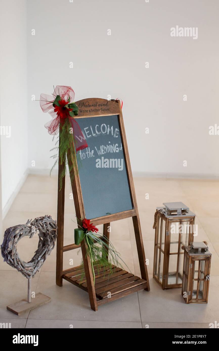 A wooden sign reads welcome placed on a table in a restaurant. Handmade ...