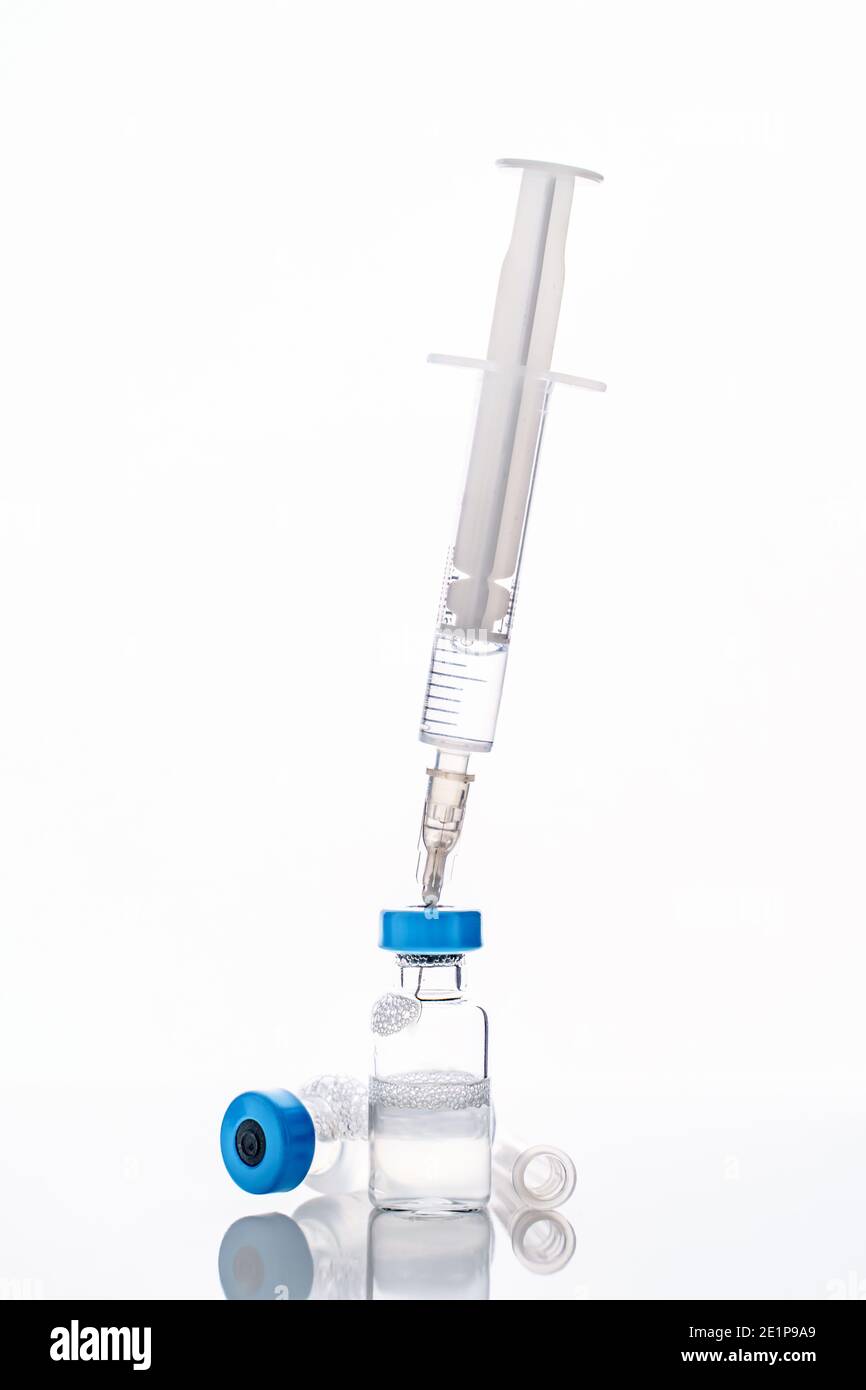 Close up on syringe with needle and vaccine injection isolated on white ...