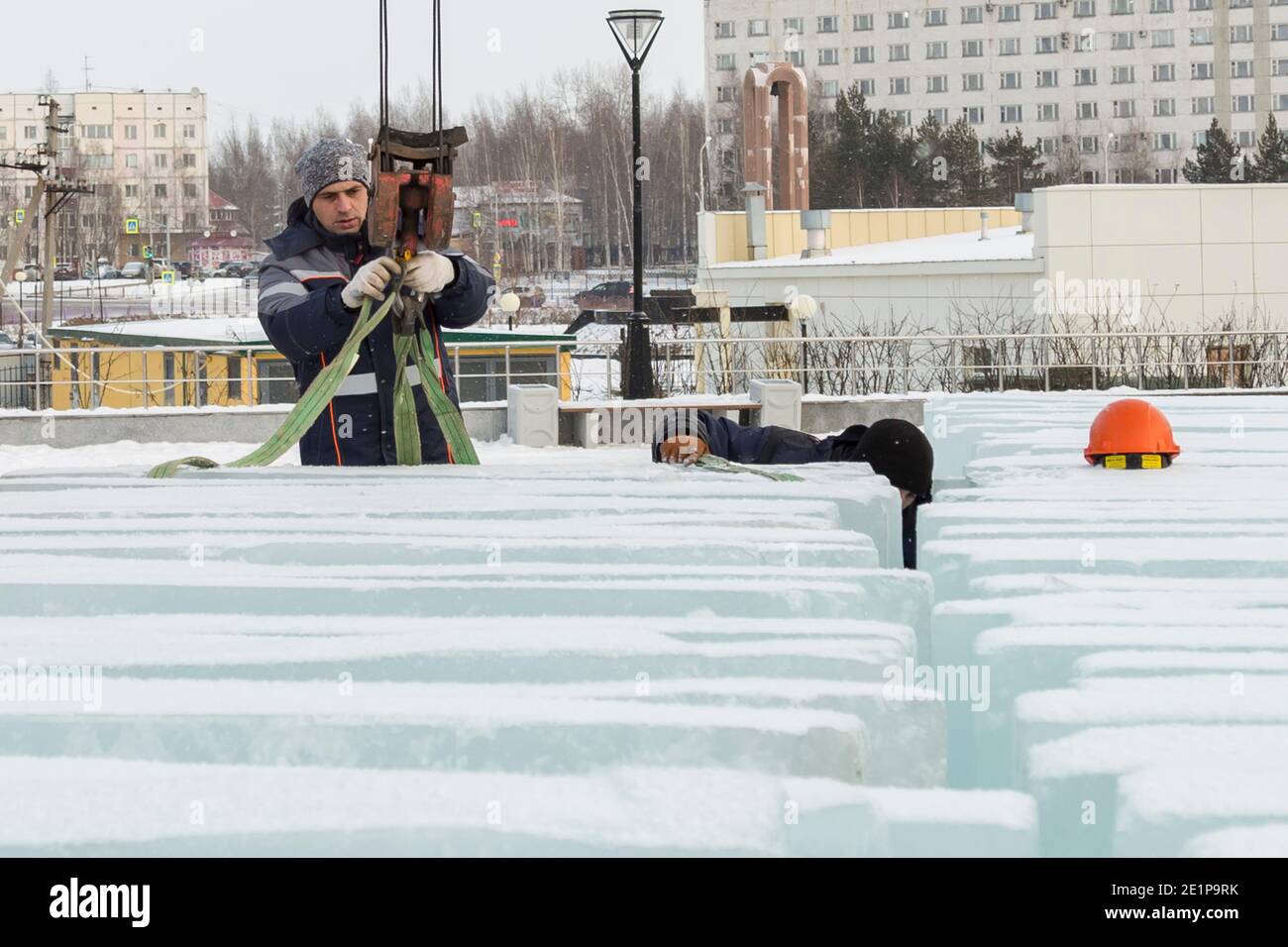 Assemblers unload ice panels from a car using a crane Stock Photo - Alamy