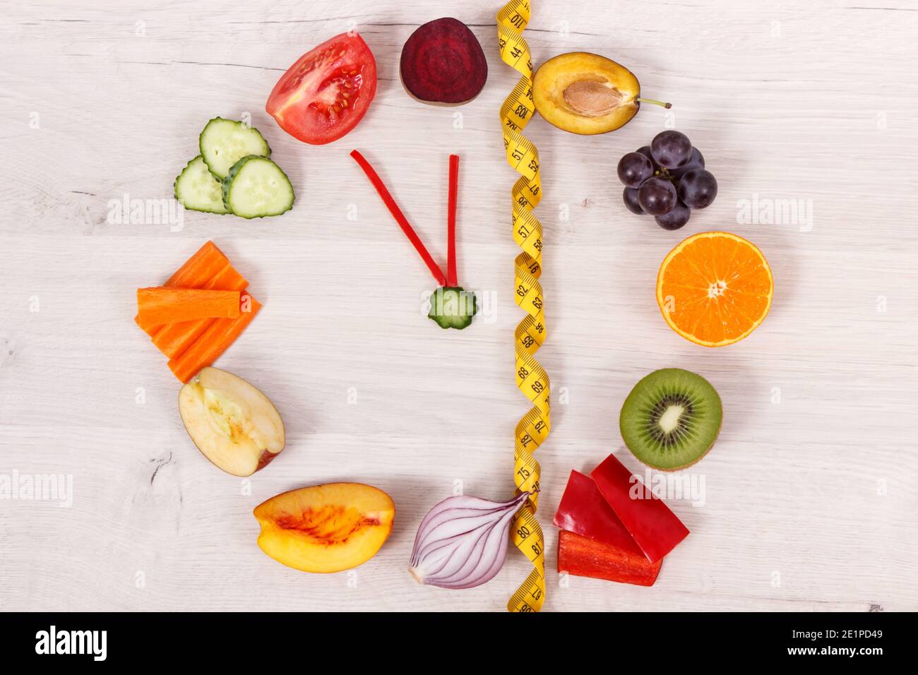 Clock made of fruits and vegetables showing time of 23 hours 55 minutes ...