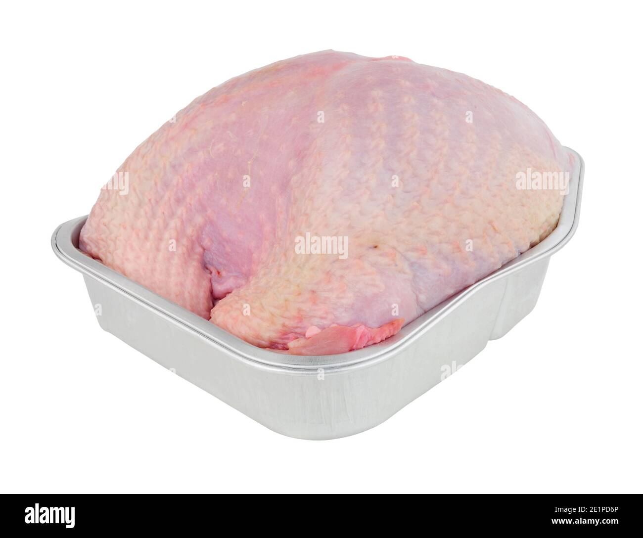 Whole raw turkey crown meat in a foil roasting tray isolated on a white ...