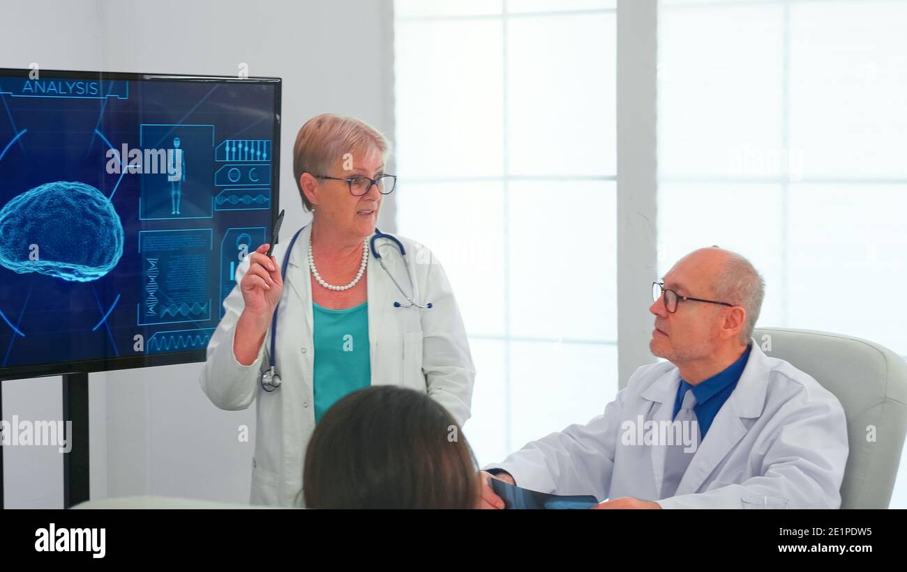Neurologist reading brain waves on monitor while doctor is wearing ...