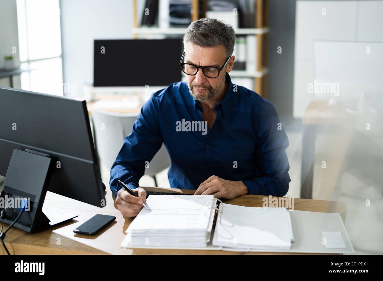 Older man wearing glasses with computer hi-res stock photography and ...