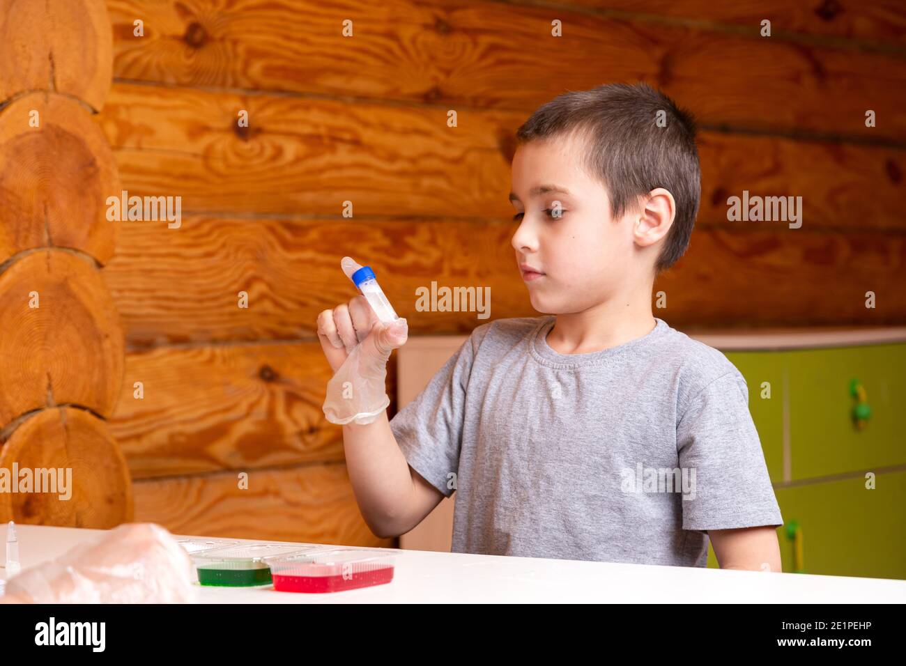 Chemistry education and training concept. Cheerful boy shakes a test ...