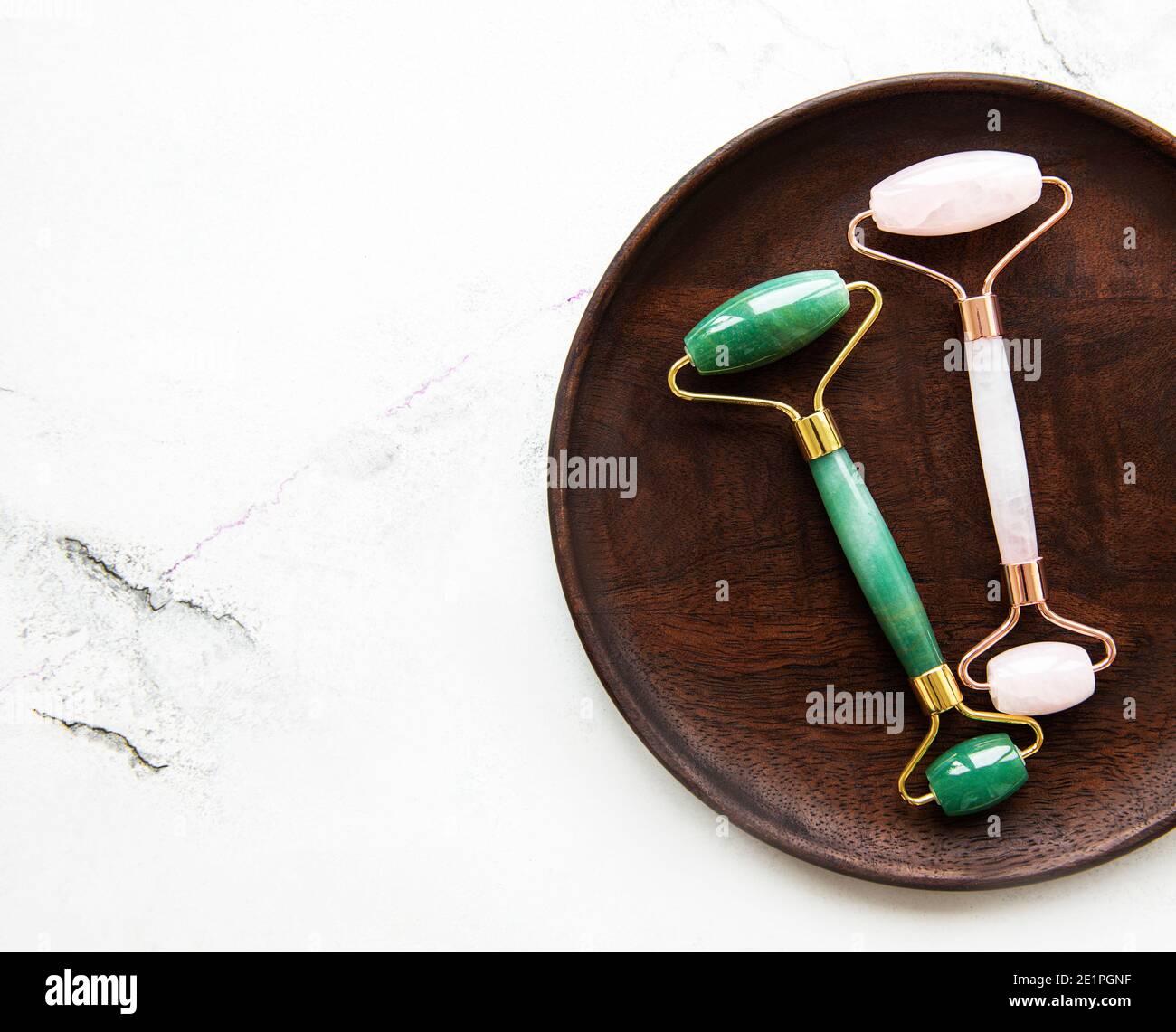 Jade face rollers for beauty facial massage therapy. Flat lay on white ...