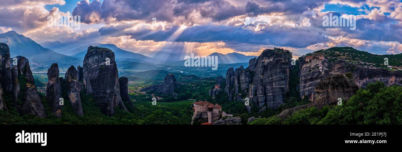 Panorama of Meteora, Greece, valley and mountains at sunset. Sun rays ...