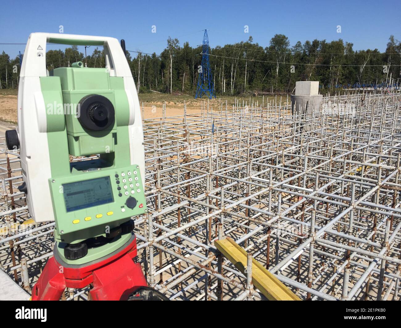 Geodetic total station on the top of the bridge pillar with scaffolding ...
