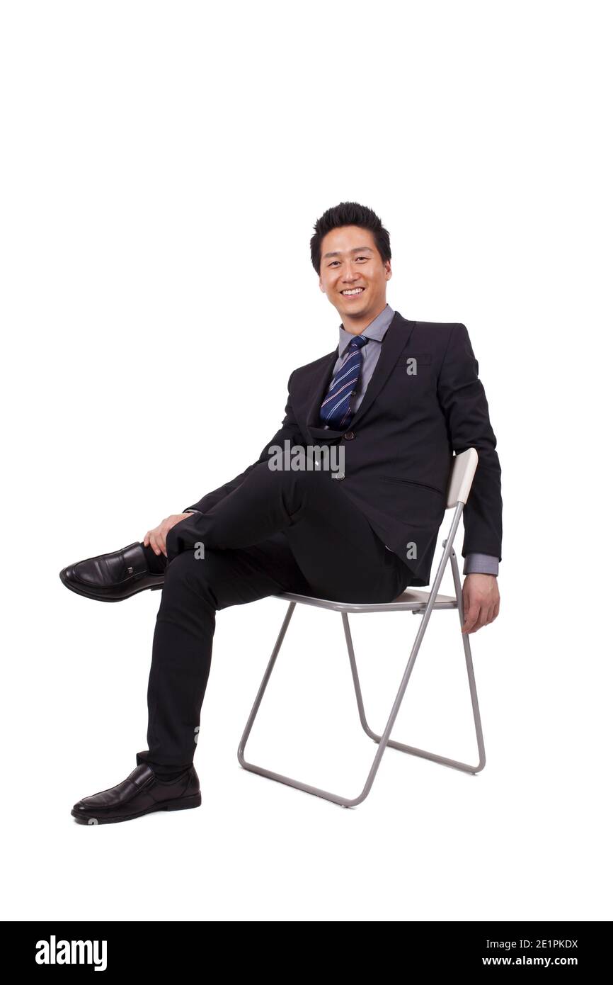 A Cheerful young business man sitting posture high quality photo Stock ...