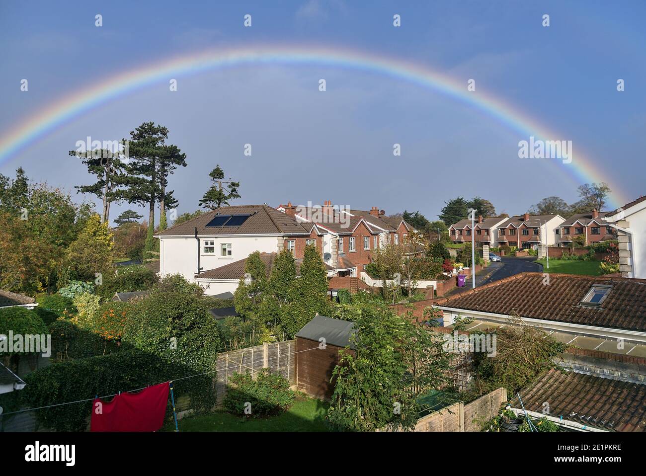 View of houses and gardens in southern Dublin with beautiful rainbow ...