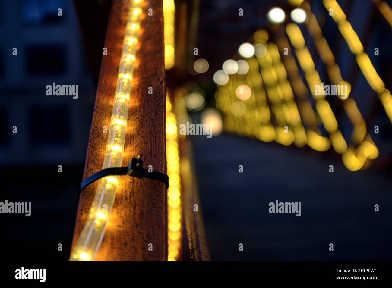 Yellow bright light bulb lighting an iron bridge in Girona, Catalonia ...