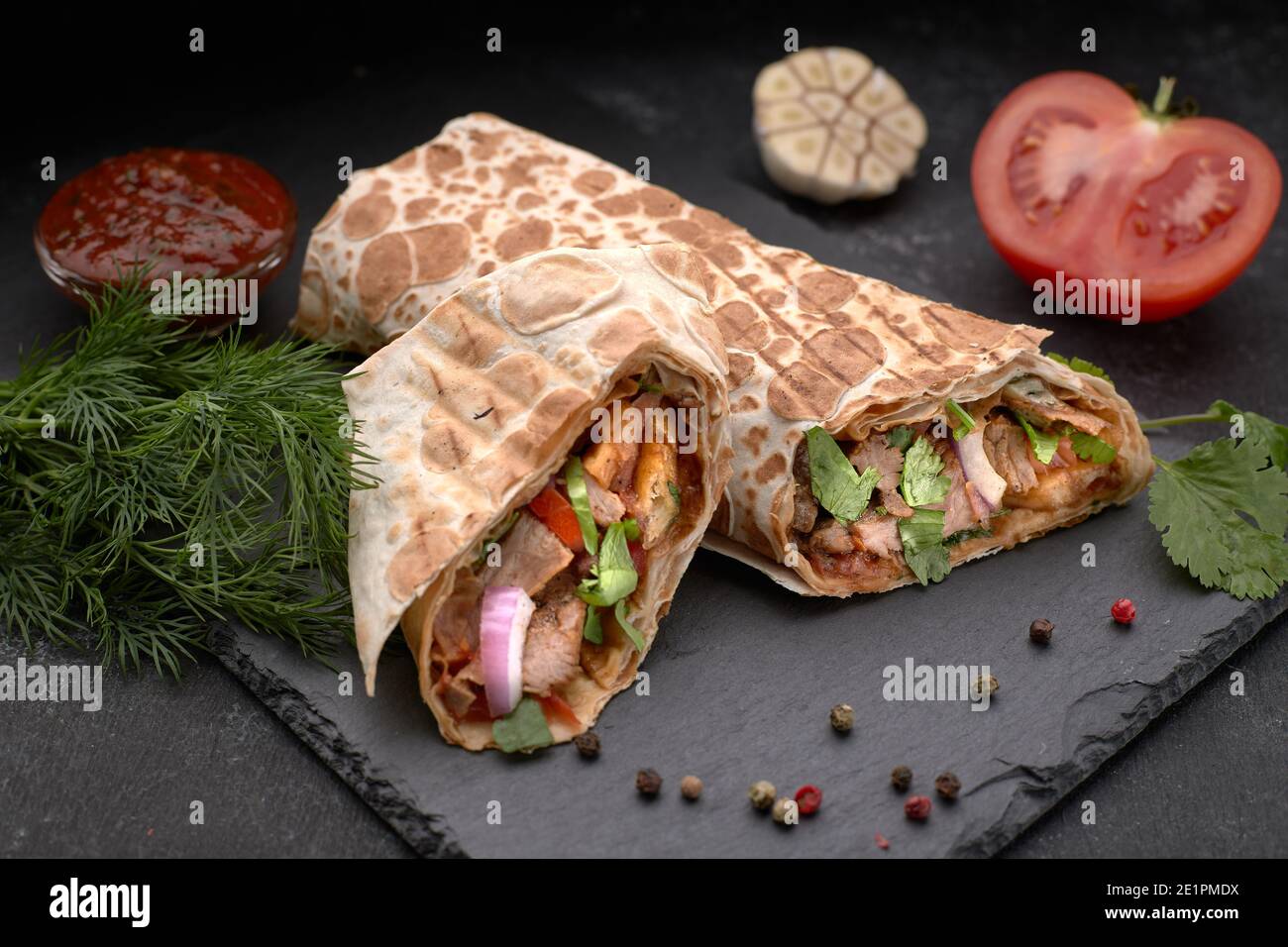 Shawarma with meat, cutaway, with sauce, tomatoes, cheese, herbs and ...