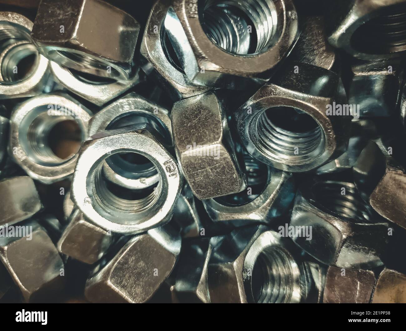 Metallic texture with a lot of new nuts Stock Photo - Alamy