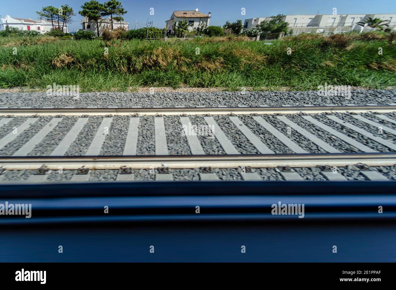 Landscape and railroad tracks seen from the train window during the ...