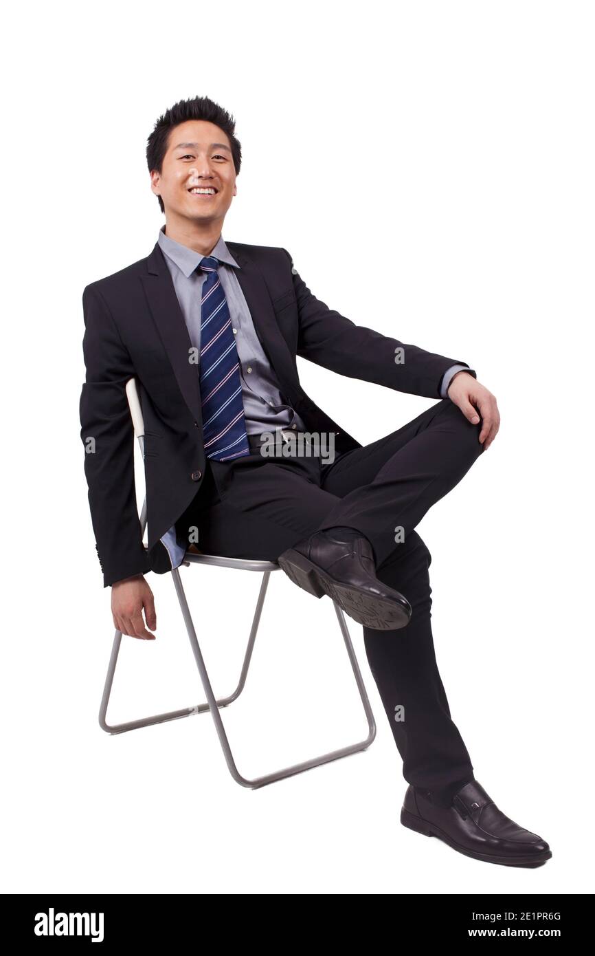 A Cheerful young business man sitting posture high quality photo Stock ...