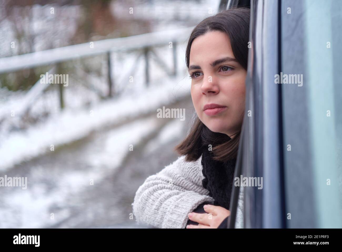 Woman looking out window snow hi-res stock photography and images - Alamy