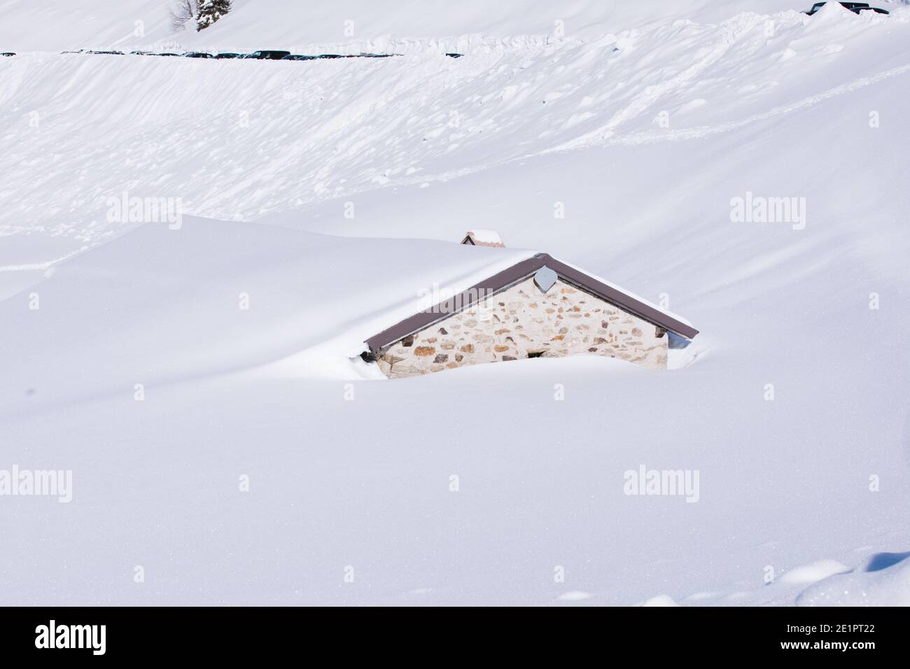 Heavy snowfall covering the mountain house up to the roof. Untouched ...