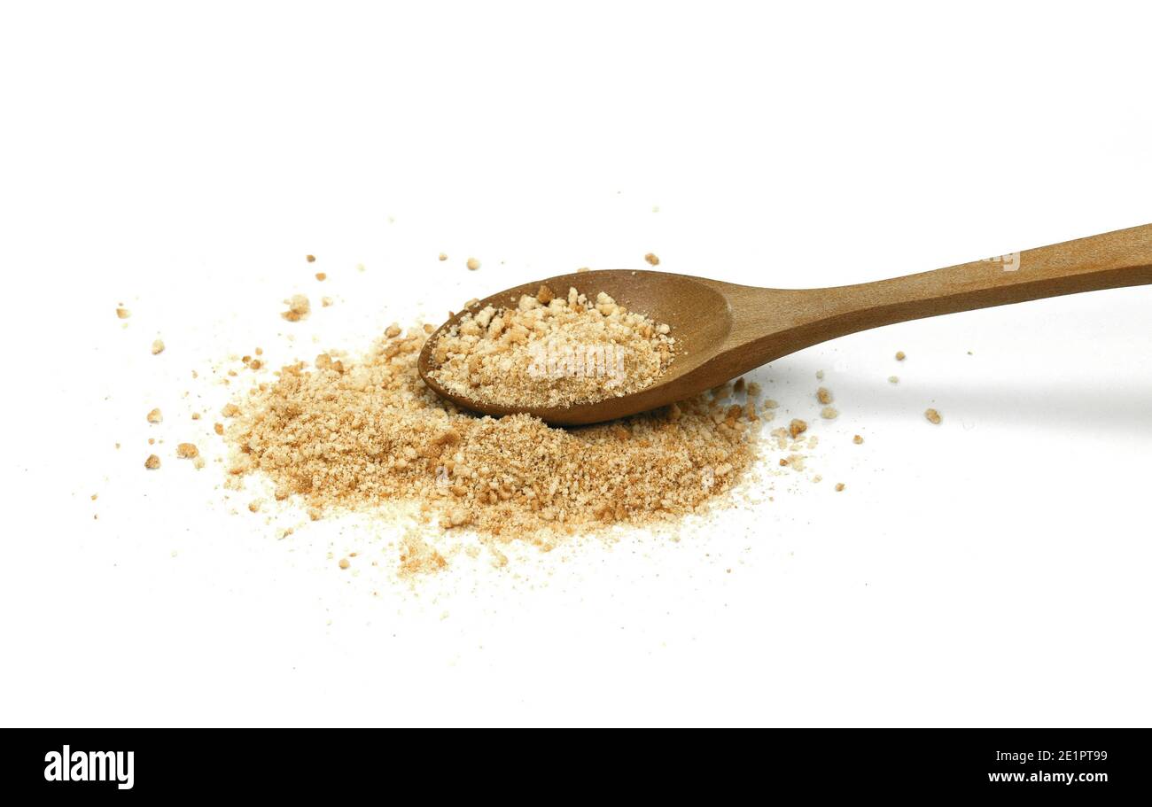 Ground biscuits in a wooden spoon on white background Stock Photo - Alamy