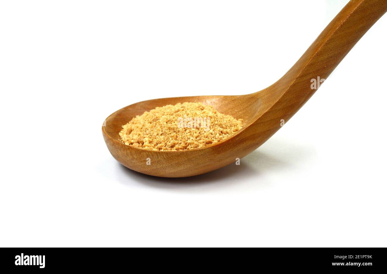 Ground biscuits in a wooden spoon on white background Stock Photo - Alamy