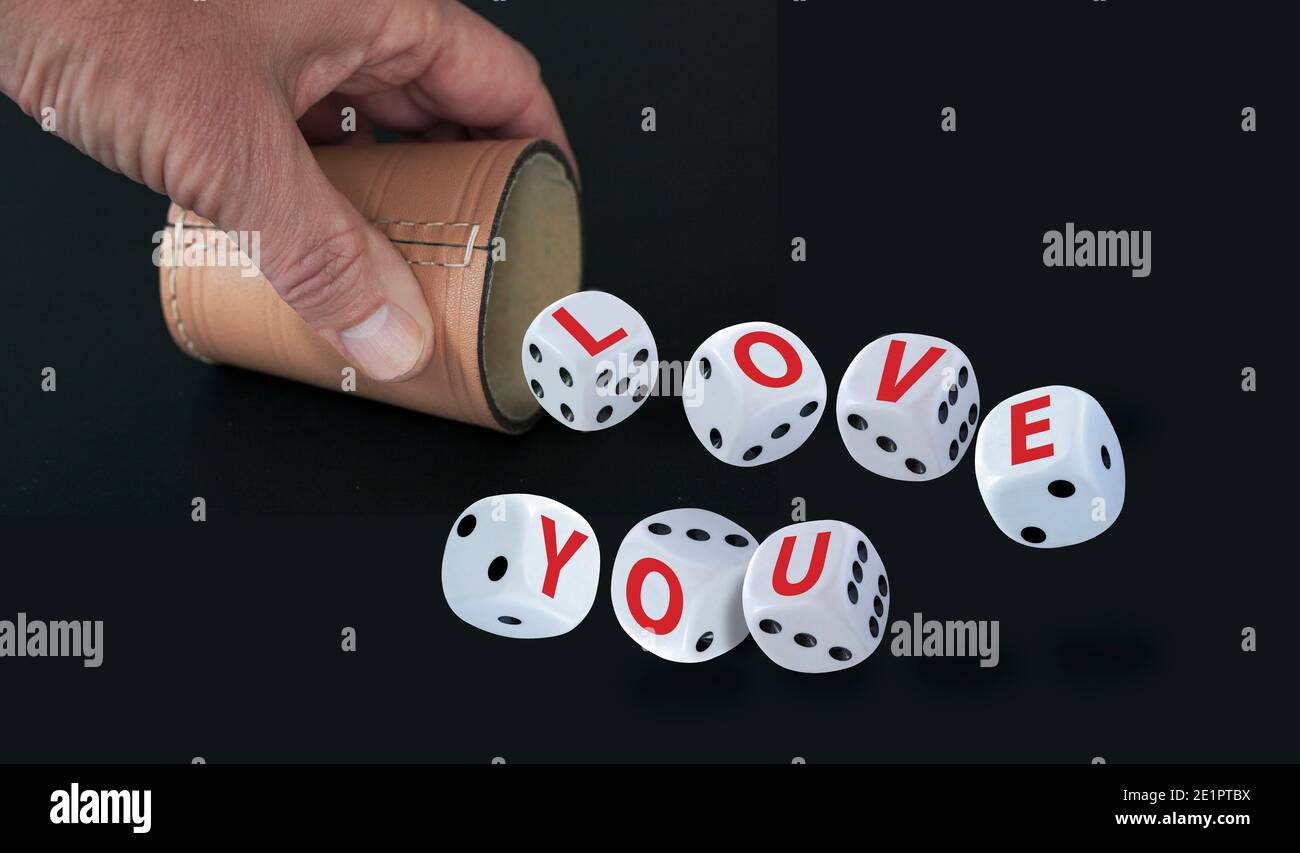 White dice with black eyes numbers spelling LOVE YOU in red letters ...