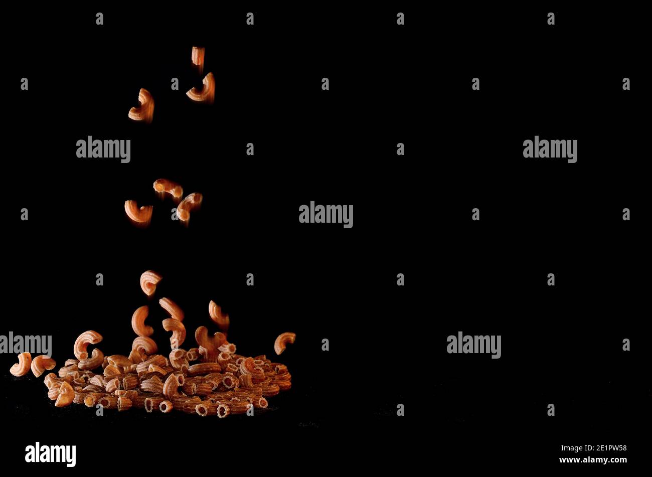 noodles fall on a heap with black background Stock Photo - Alamy
