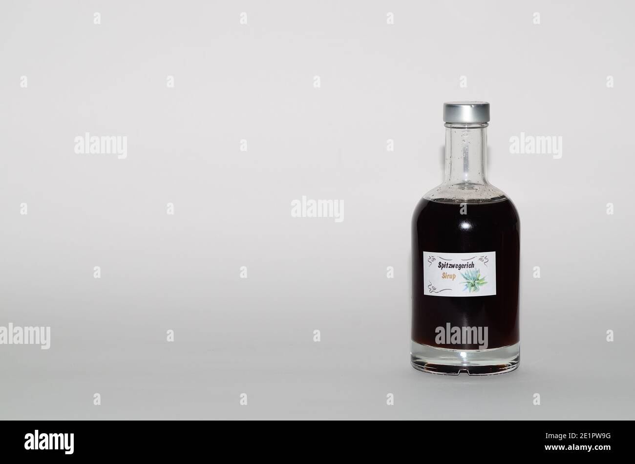 healthy ribwort plantain syrup on white background Stock Photo - Alamy