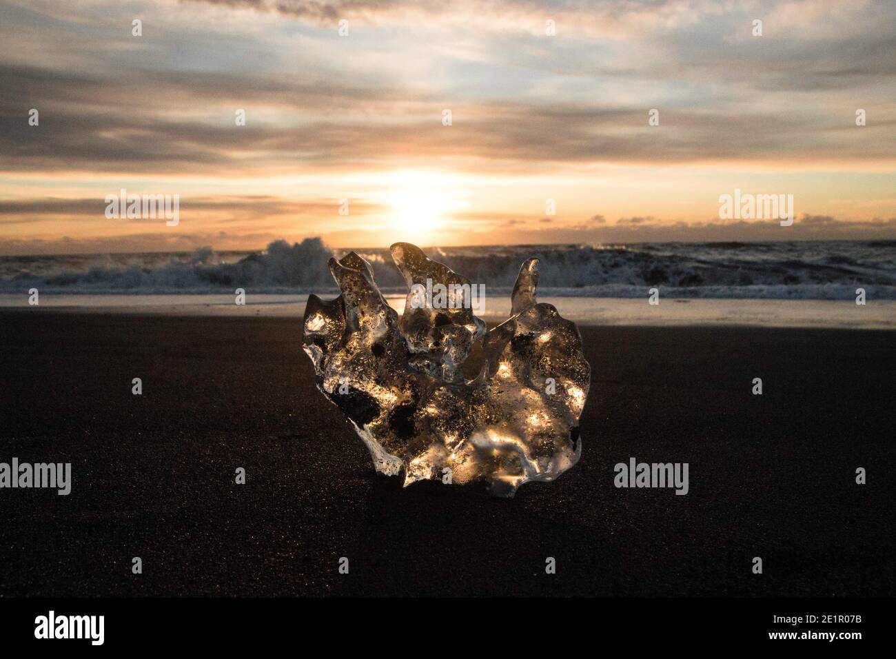 Ice crystal part piece iceberg block glacial fragment on black sand ...