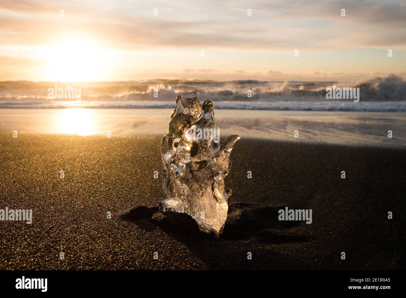 Ice crystal part piece iceberg block glacial fragment on black sand ...