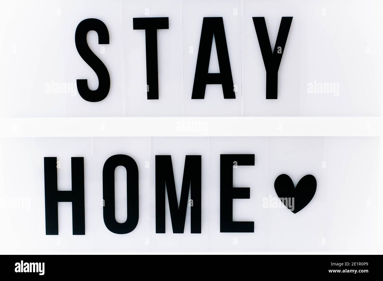 Lightbox with text STAY HOME, close up . Stay safe, stay inside home ...