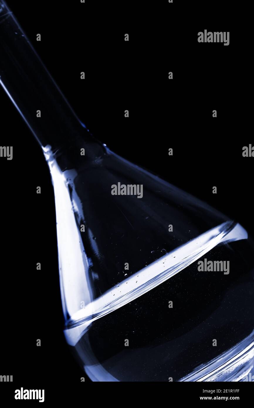 Scientific laboratory flask on the black background Stock Photo - Alamy